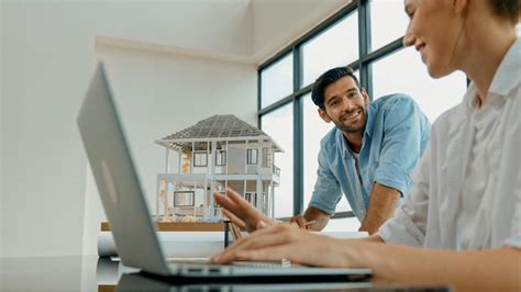 Premium Photo Engineer Measure Model While Coworker Using Laptop