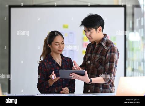 Web Developer Team Using Modern Device And Working On Mobile