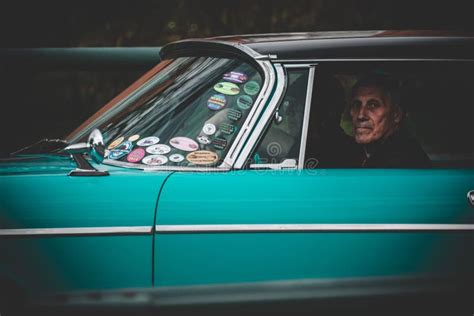 Elderly Man Driving An Old Vintage Cyan Car During A Cruising Event In Sweden Editorial Photo
