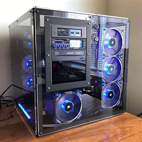 A Computer Tower With Speakers On It Sitting On Top Of A Wooden Table In Front Of A Window