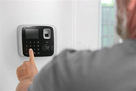 Mature Man Entering Code On Alarm System Keypad Stock Photo Image Of Electronic Adult 124899850