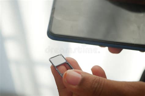 Inserting A Sim Card Into A Smartphone Device For Connectivity Setup Stock Image Image Of