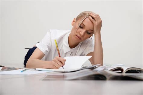 Premium Photo Young Beautiful Woman Takes Notes Prepares For Classes Writes Lecture In Notebooks