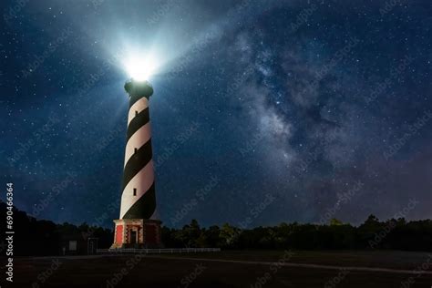 Poster Historic Cape Hatteras Lighthouse Shines Brightly In A Night Sky