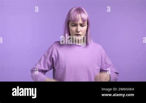 Angry Offended Woman With Dyed Purple Hair Keeping Arms Crossed And Staring At Camera With