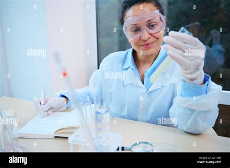 Multi Ethnic Woman Lab Technician Scientist Testing The Chemical