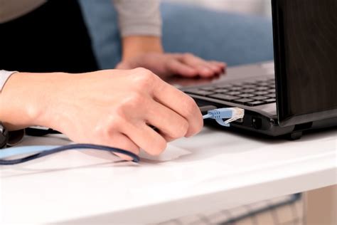 Premium Photo Women Hand Is Plugging In The Lan Cable To Laptop Port
