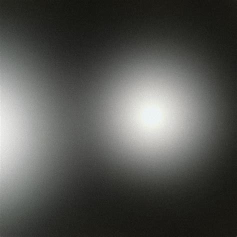 Abstract Grainy Texture With Two Light Spots Creating A Gradient On Black Background Premium
