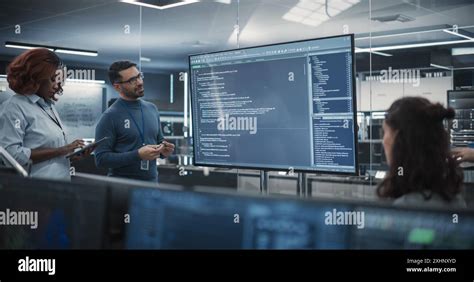 Group Of Multiethnic Software Developers Having A Meeting In Order To Review The Code Done By Group Of Multiethnic Software Developers Having A Meeting In Order To Review The Code Done By