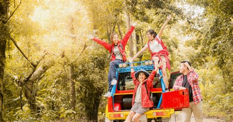 4wd를 가진 행복한 아시아 젊은 여행자는 숲의 도로에서 차를 운전하고지도에서 길을 찾고있는 젊은 부부와 다른 두 명은 4wd 드라이브 차를 즐기고 있습니다 젊은 혼혈