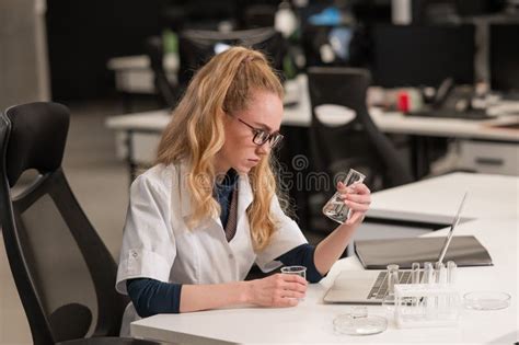 Caucasian Woman In A Medical Gown Doing Laboratory Experiments Stock Image Image Of Beaker