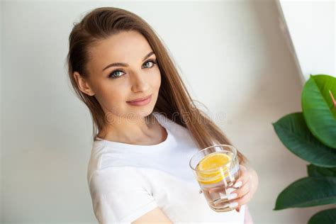 Beautiful Youthful Lady Refreshing Herself With Lemon Water Stock Image