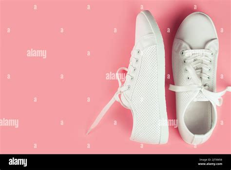 White Female Sneakers On Pink Background With Copy Space Top View