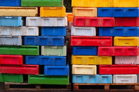 Premium Photo Colored Fish Boxes Stacked Fishing Containers