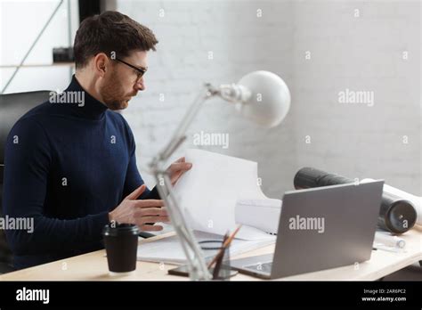 Architect Working In Office With Blueprints Engineer Inspect Architectural Plan Sketching A
