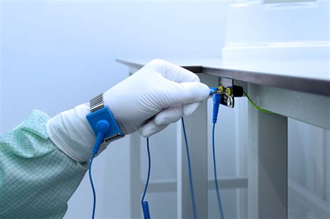 Esd 천과 장갑을 낀 남자의 손에 팔찌 정적 저항 Esd 팔찌 또는 지상 장비 정전기 방지 안전하게 접지하는 데 사용됩니다 반도체 제조 공장 산업 건물에 대한 스톡 사진