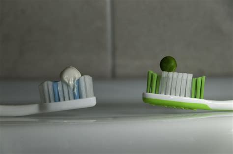 Premium Photo Closeup Of Toothpaste Squeezed On The Toothbrushes