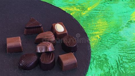Variety Of Assorted Flavors Chocolate Candies On Stone Plate Stock