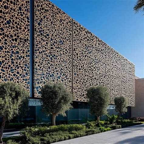 Modern Facade With Golden Ceramic Perforated Screen And Lush