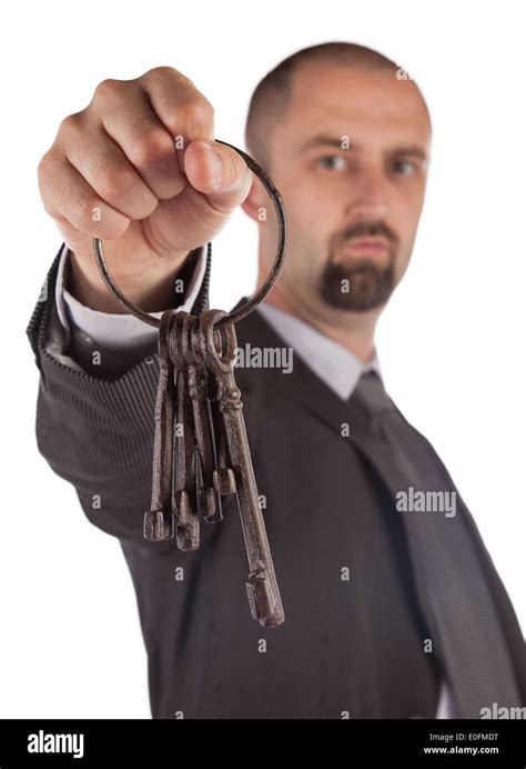 Man In Suit Giving Old Keys To A House Isolated On White Stock Photo Alamy