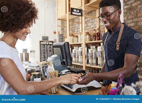 Customer Making Contactless Payment For Shopping At Checkout Of Grocery Store Using Mobile Phone