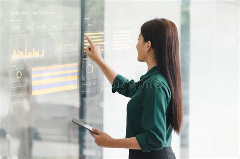 Businesswoman Interacts With A Digital Sales Dashboard Displaying