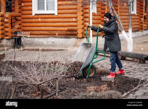 Glad Woman In Field Clothes Applying Mulching Procedure Pouring Old