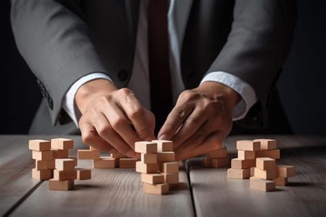 Premium Photo Business Leader Hand Wooden Cube Businessman Making Pyramid Wooden Blocks