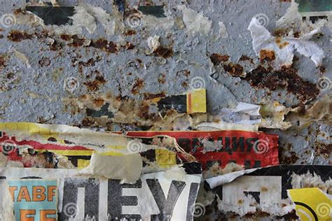 Weathered Wall Covered In Colorful Peeling Posters Revealing Layers Of