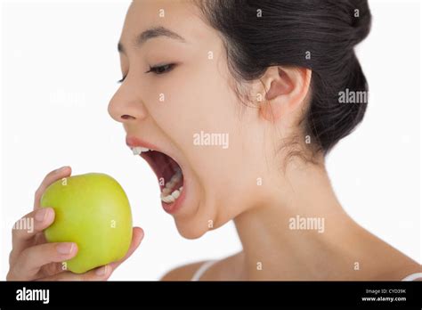 Woman Biting Into Apple Stock Photo Alamy