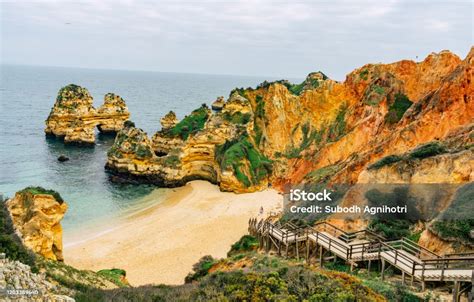 카밀로 비치 알가르베 배경에 청록색 바다와 포르투갈 해변 프라이아 두 카밀로 포르투갈에 나무 인도 교 라고스 알가르베 포르투갈의 카밀로 해변의 멋진 전망 0명에 대한 스톡
