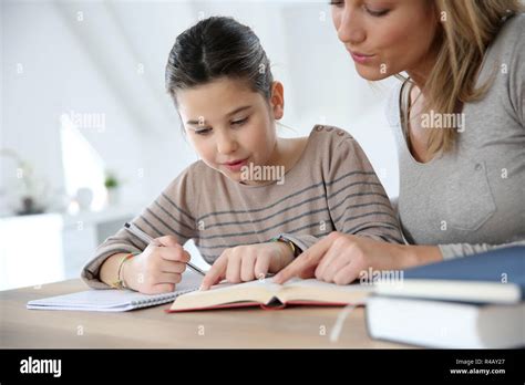 Mom Helping Kid With Homework Stock Photo Alamy