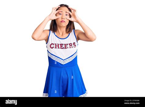 Young Beautiful Chinese Girl Wearing Cheerleader Uniform Trying To Open