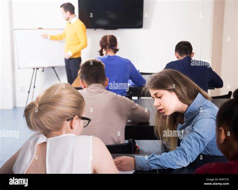 Female Babe Is Cheating On And Looking Test Answers In Her Neighbors Work Stock Photo Alamy