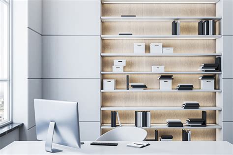 세련된 책상 컴퓨터 책과 상자로 가득 찬 조명이 켜진 선반이 있는 현대적인 사무실 인테리어 현대적인 작업 공간 디자인 3d 렌더링 0명에 대한 스톡 사진 및 기타 이미지