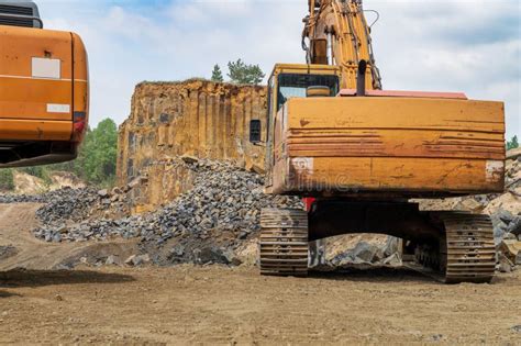 Basalt Mining Yellow Excavators In A Basalt Quarry Near The Forest
