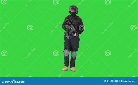 Swat Operator With Assault Rifle Walking On A Green Screen Chroma Key