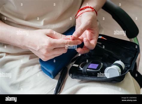 Diabetes Woman Testing The Amount Of Blood Glucose With A Portable Home Glucose Meter Or Blood