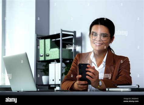 Woman Using Smartphone With Facial Recognition System In Office Security Application Scanning
