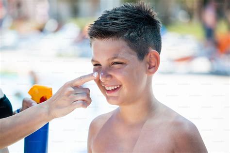 Mother Applying Sunblock Cream On Son Face Mother Put Sunblock Cream