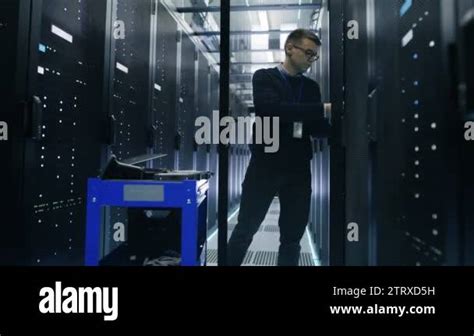 Server Engineer Changes Hard Drives In Open Cabinet Of Rack Server He S Works In Big Data