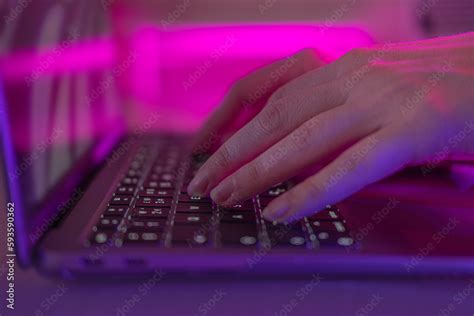 Person Typing At Laptop Computer At Night Female Uses Keyboard Shakes Buttons With Fingers
