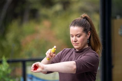 Premium Photo Woman Applying Bug Spray Girl Spraying On Bug Spray