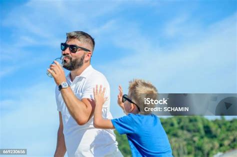 Portrait Of Father Teasing And Not Giving Water To His Thirsty Handsome