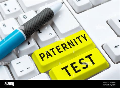 Hand Writing Sign Paternity Test Word Written On A Test Of DNA To