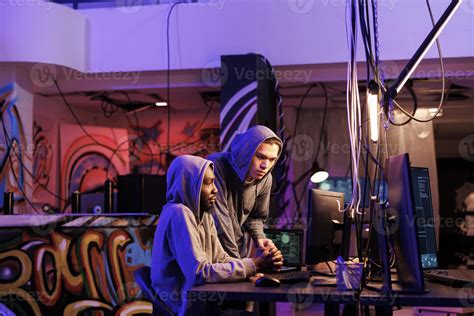 Hacker And Crime Partner Working Together And Planning System Breach In Abandoned Warehouse