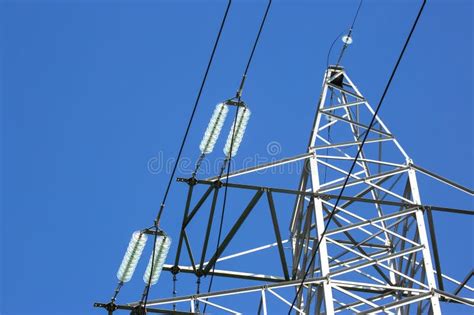 High Voltage Tower With Electrical Voltage Wires Isolates Close Up Against The Background Of