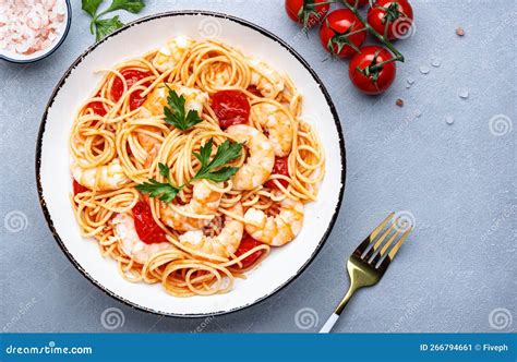 Spaghetti Pasta With Shrimp Cherry Tomatoes Olive Oil And Parsley On Gray Table Background