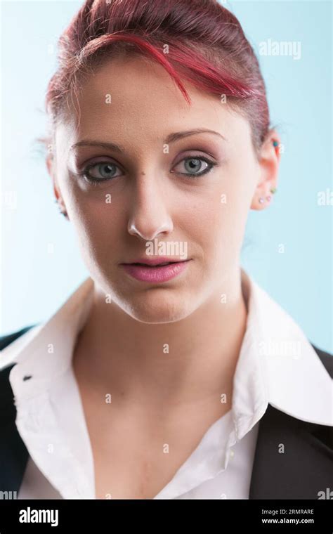 Young Redhead In A Formal Suit And Open White Blouse Contemplates Her