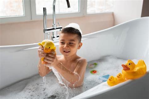 Free Photo Medium Shot Boy Playing In Bathtub